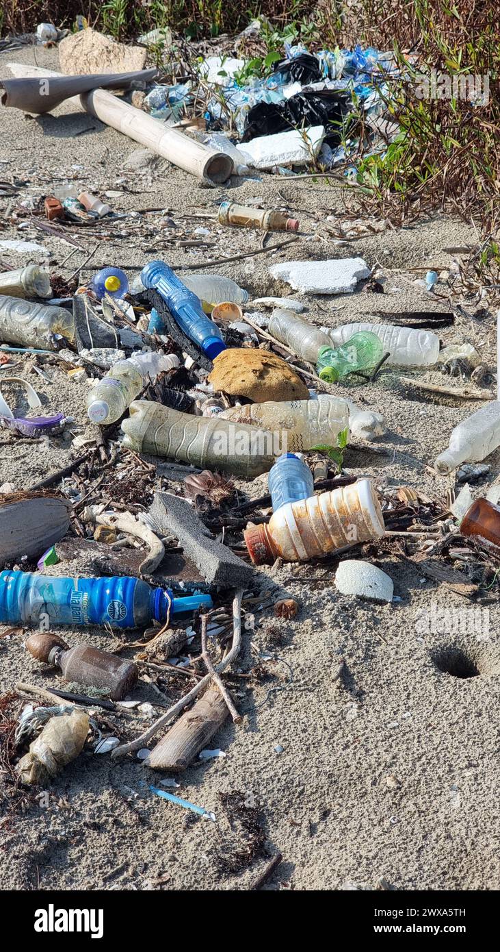A chaotic array of glass bottles scattered on the ground, creating a ...