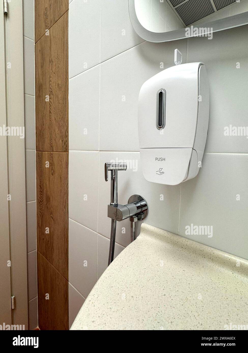 soap dispenser in small public toilet Stock Photo - Alamy