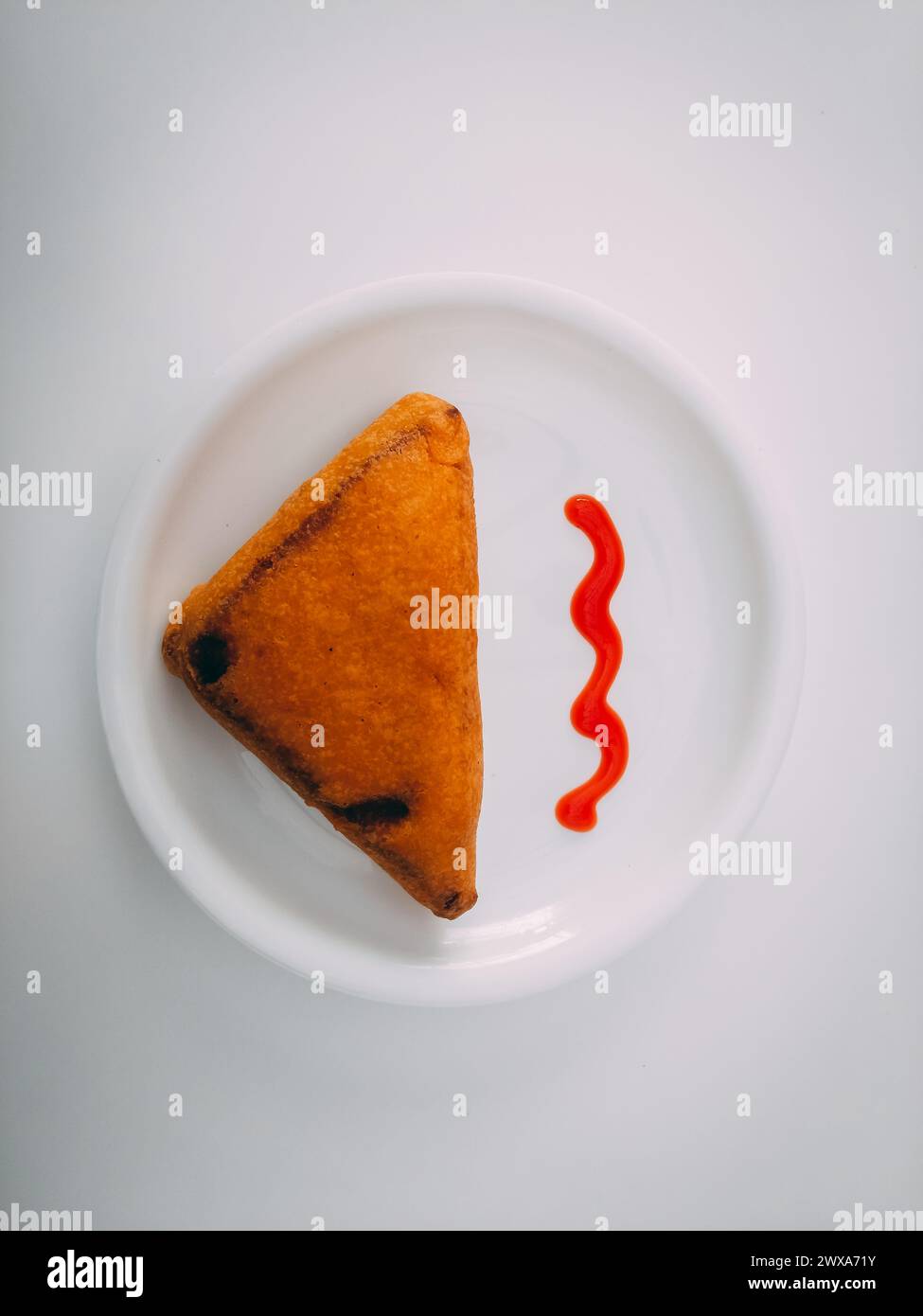 A vertical top view of a plate with Bread Pakoda and tomato sauce Stock ...