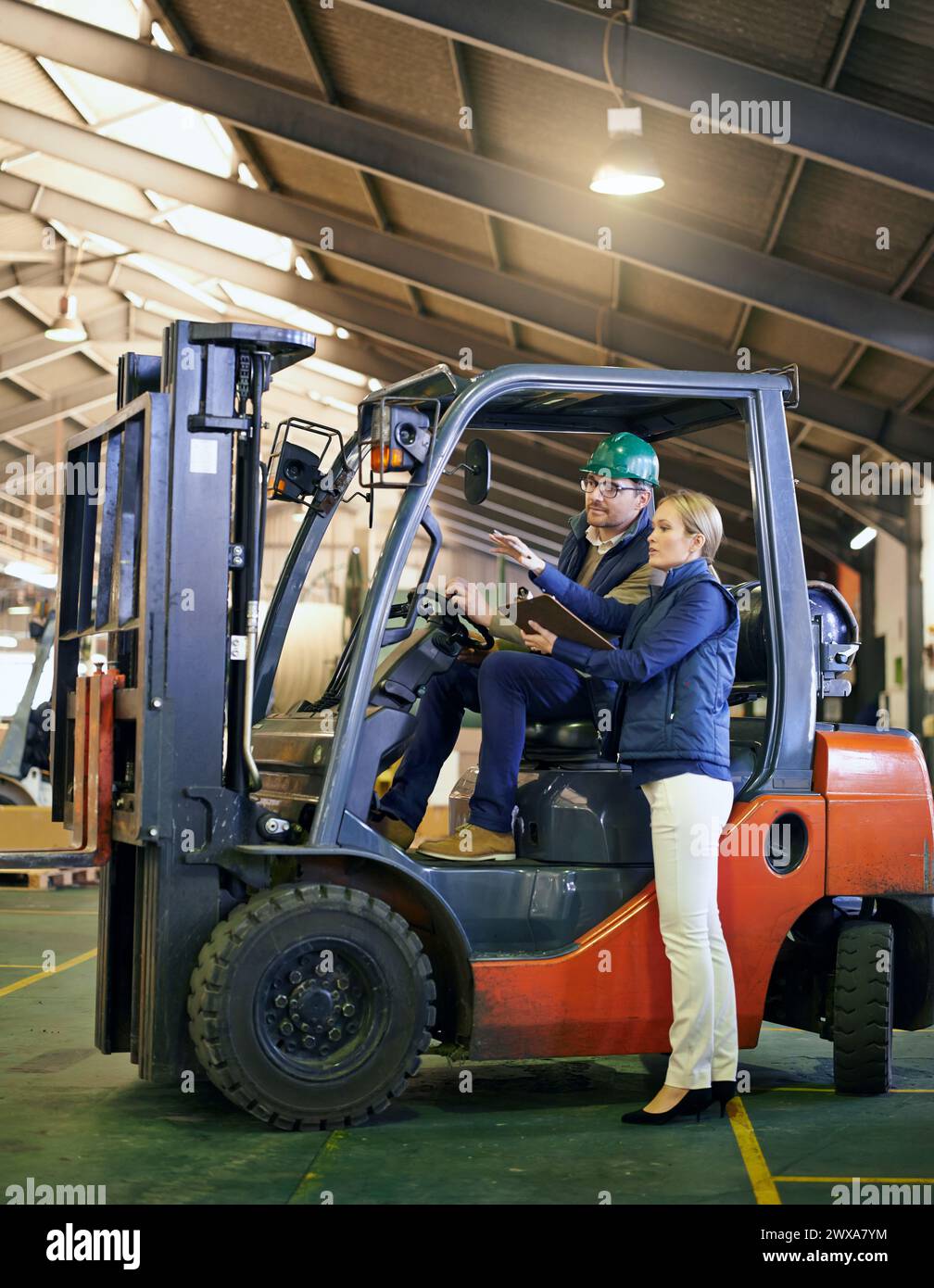 Talking, warehouse and workers with forklift working on site, loading ...