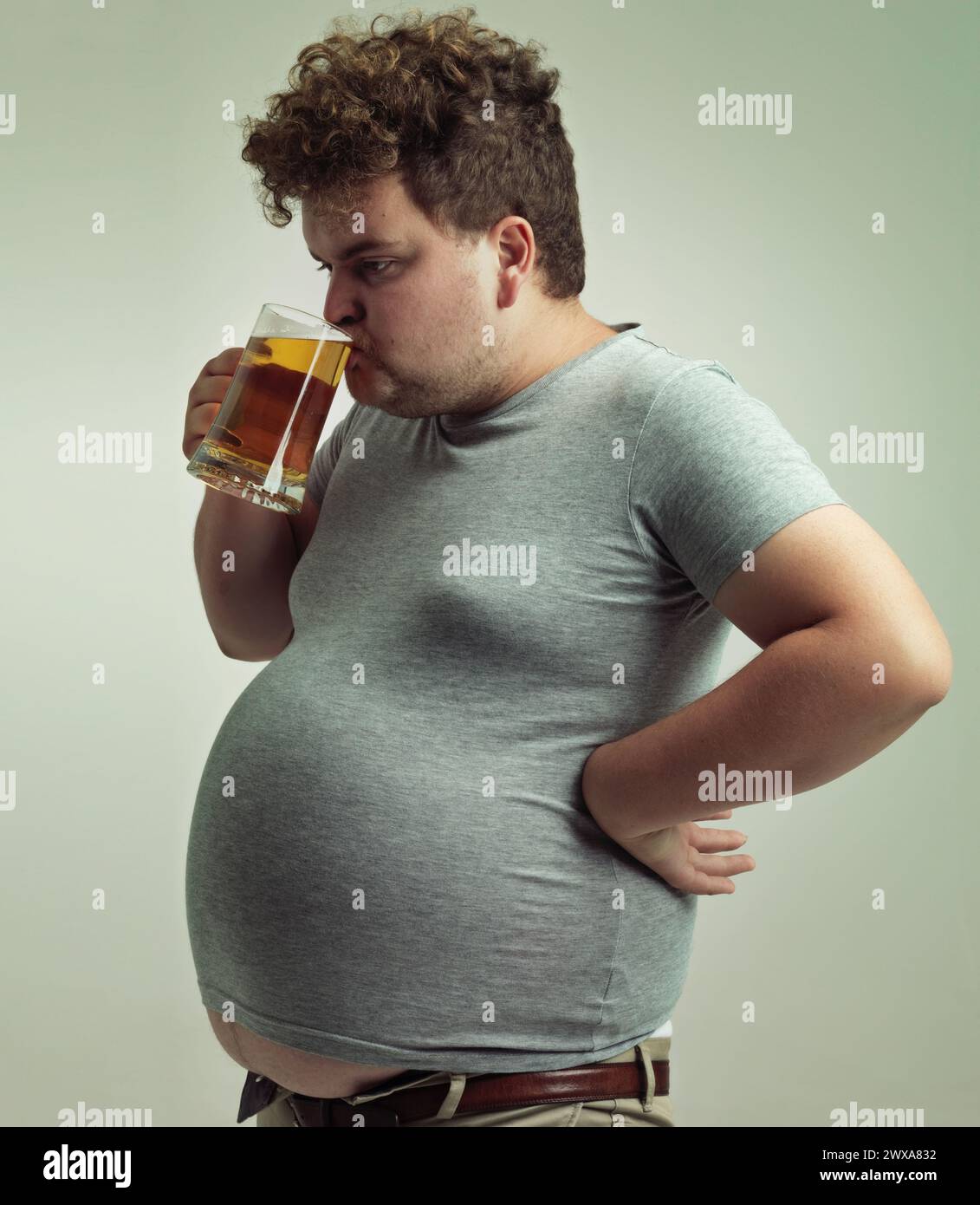 Plus size, man and drinking alcohol for unhealthy habit, belly and ...