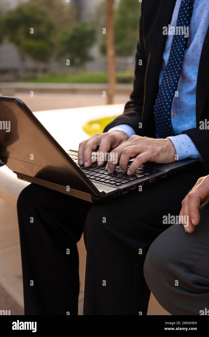 Vertical portrait unrecognizable businessman working on his laptop ...