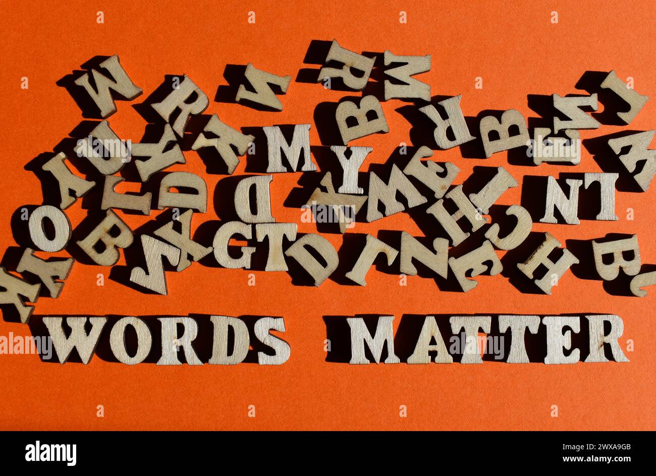 Words Matter, in wooden letters with random alphabet letters above ...