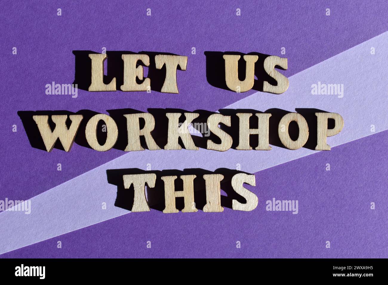 Let Us Workshop This, words in wooden alphabet letters isolated on ...