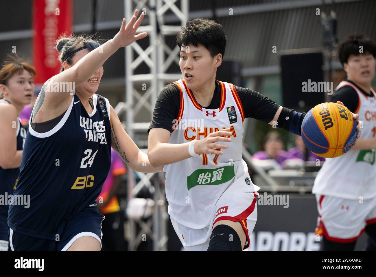 Singapore. 29th Mar, 2024. Ha Wenxi (R) of China dribbles during the ...