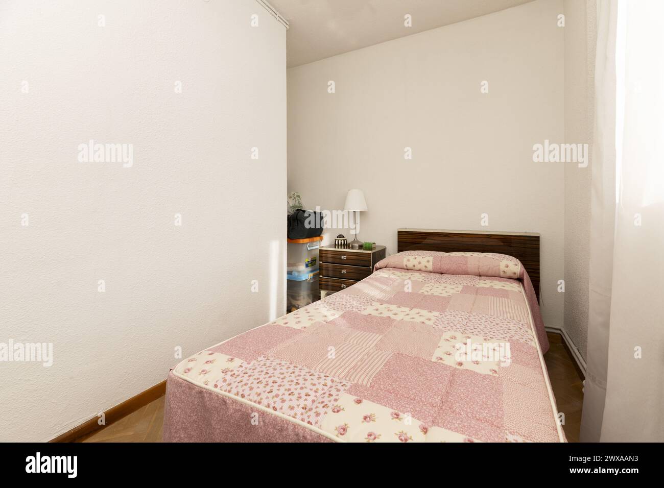 Small room in a home dedicated to a bedroom with a single bed with a ...