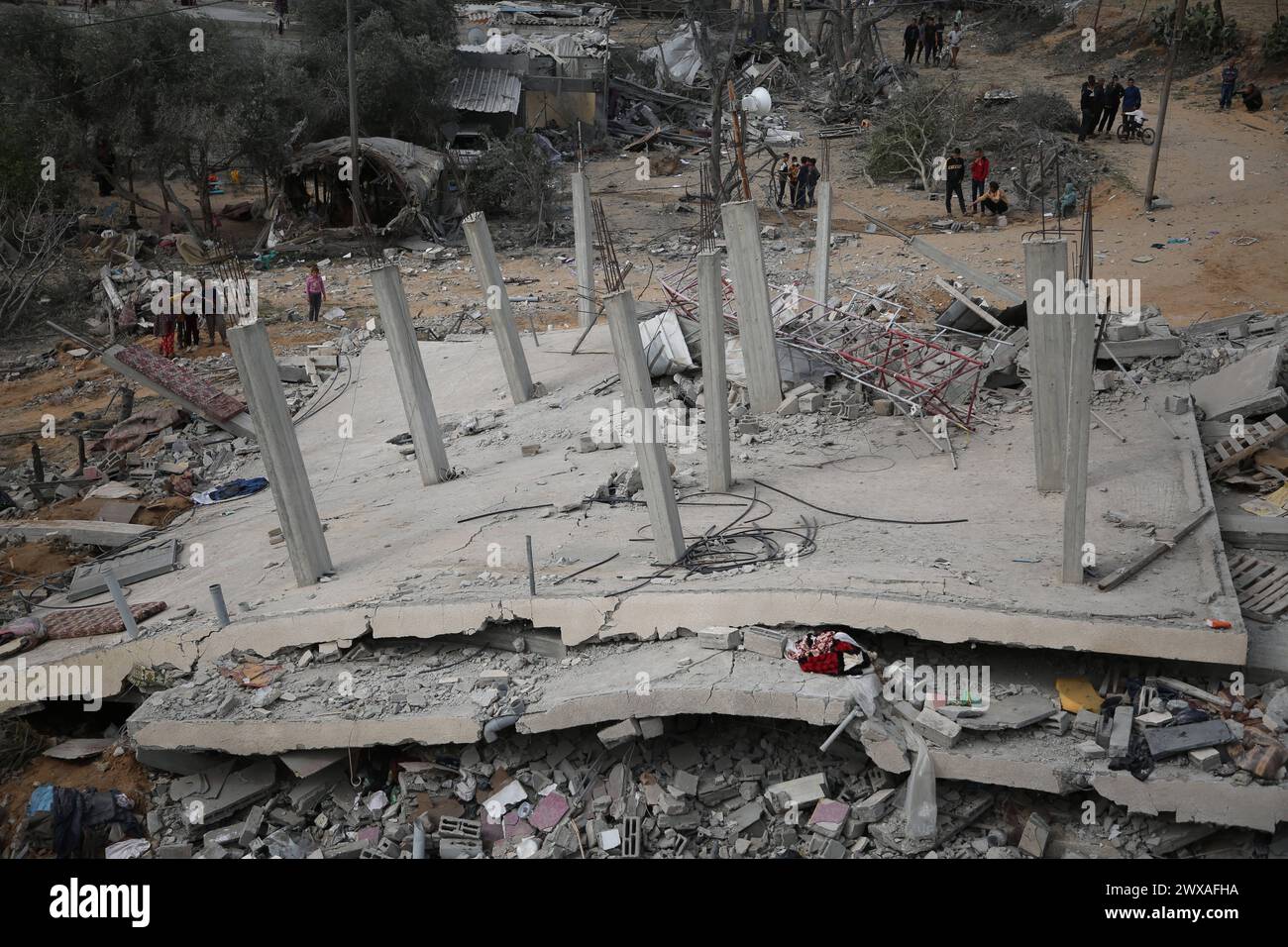 Palestinians inspect the damage to a building after overnight Israeli ...