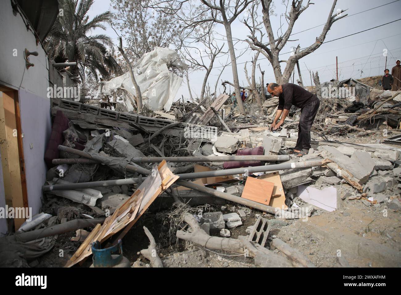 Palestinians inspect the damage to a building after overnight Israeli ...