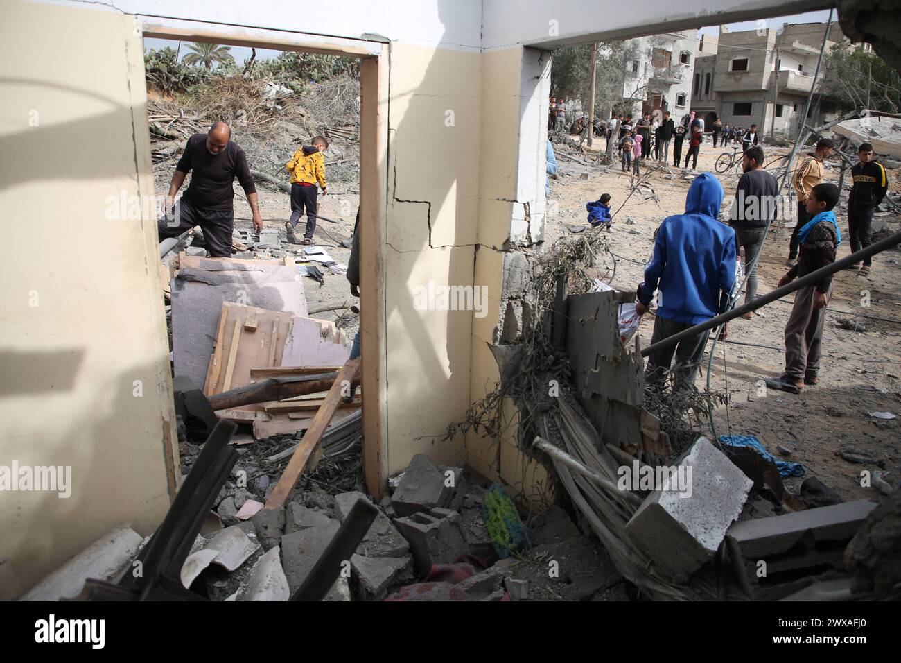 Palestinians inspect the damage to a building after overnight Israeli ...