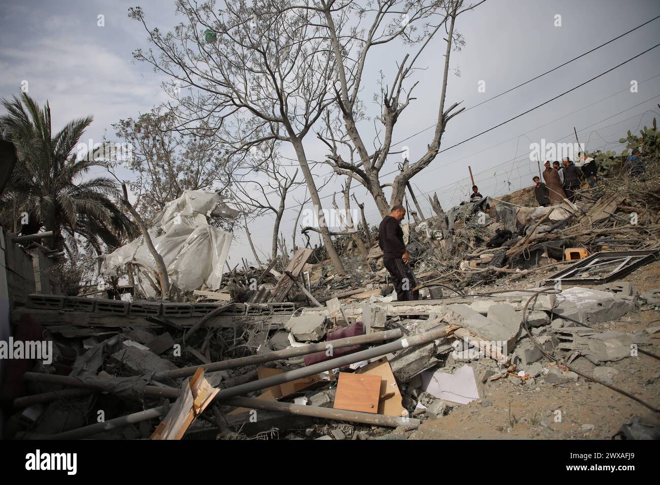 Palestinians inspect the damage to a building after overnight Israeli ...