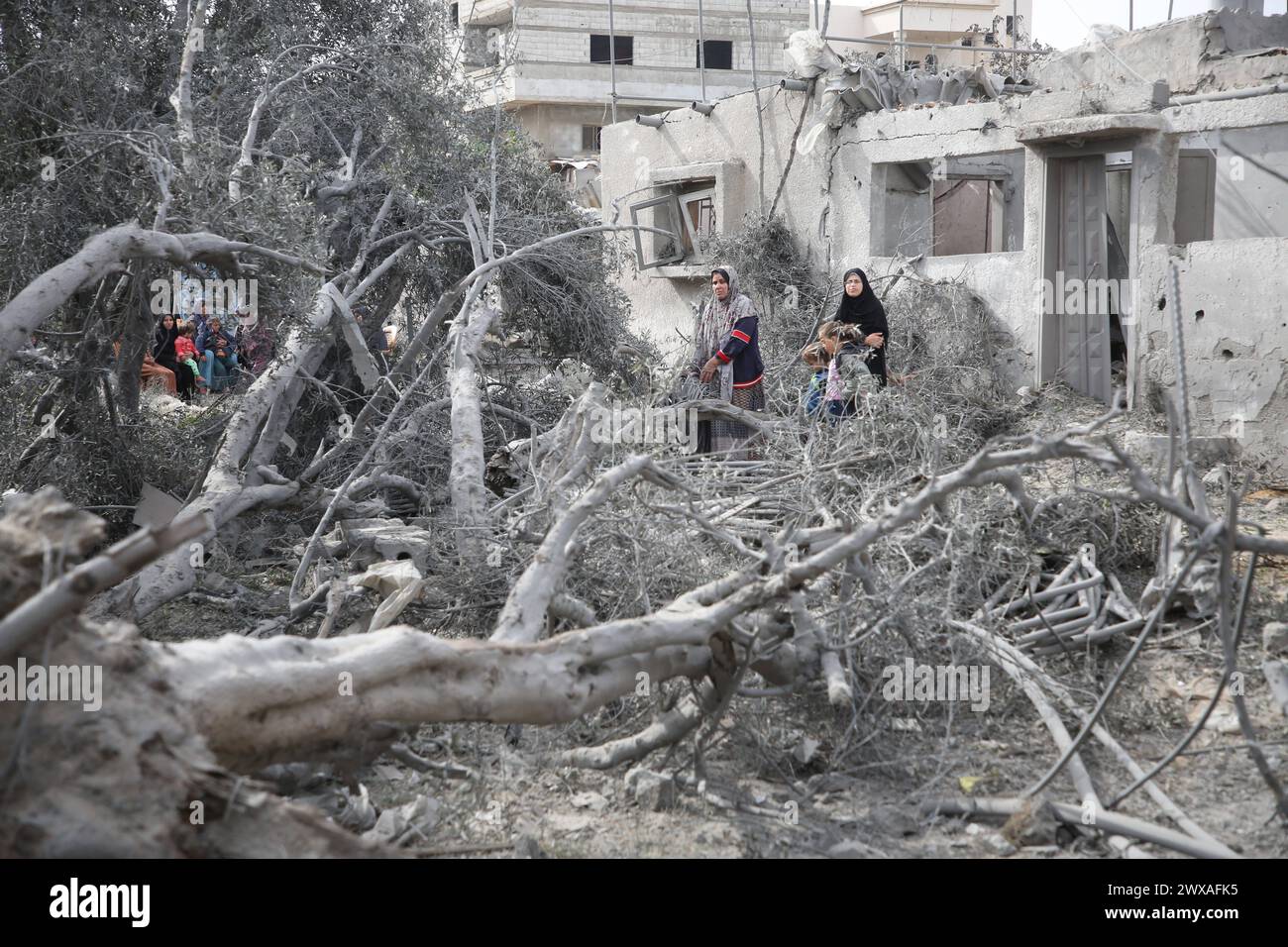 Palestinians inspect the damage to a building after overnight Israeli ...