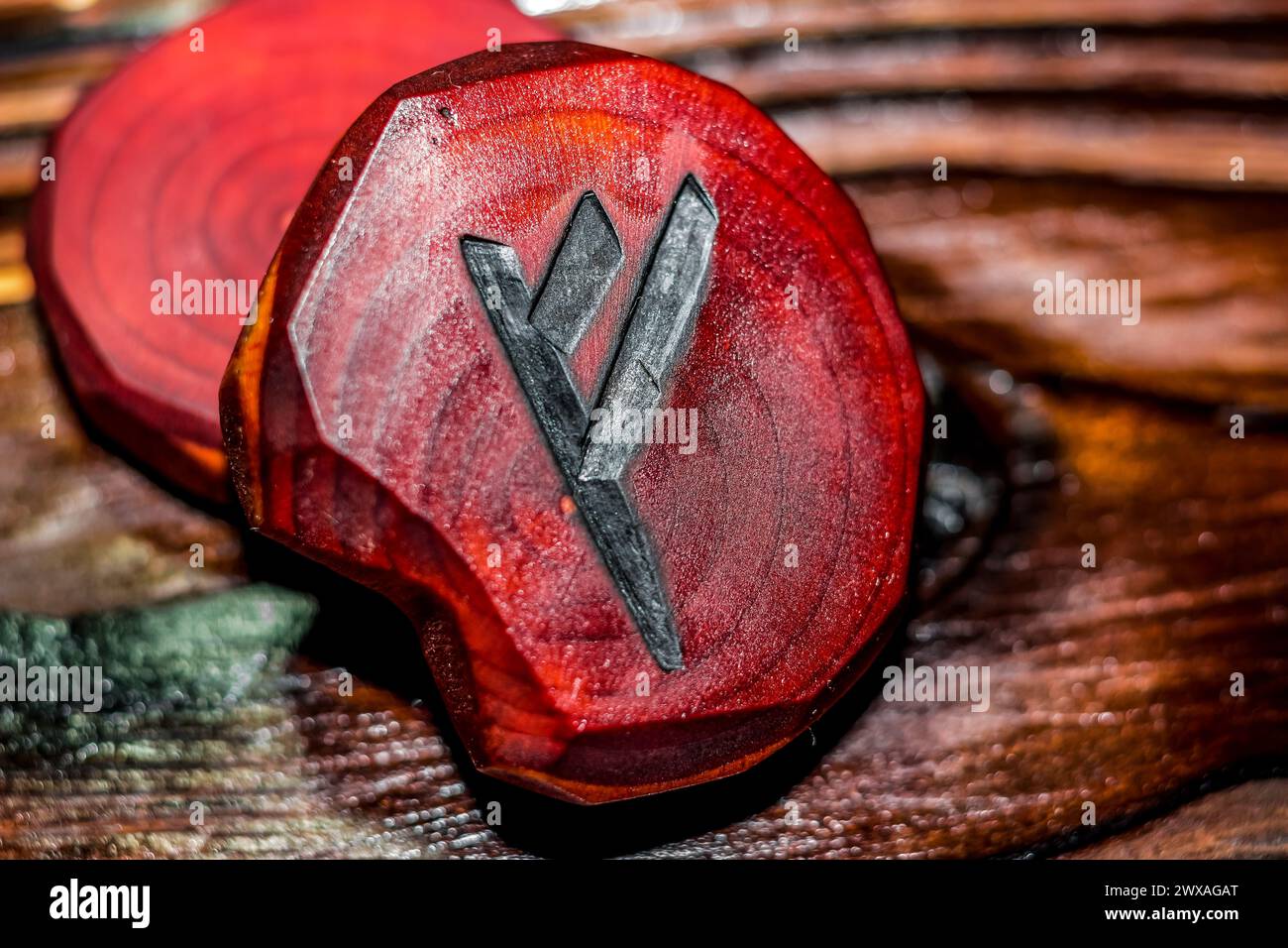 Rune Fehu red color carved from wood on a wooden background - Elder ...