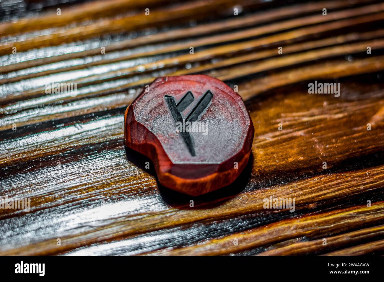 Rune Fehu red color carved from wood on a wooden background - Elder ...