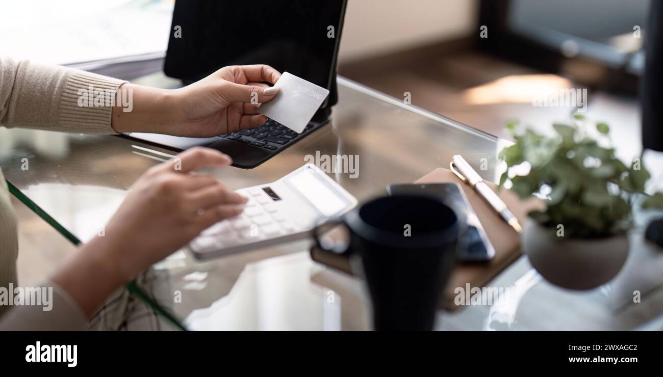 Young woman calculating monthly home expenses, tax, bank account ...