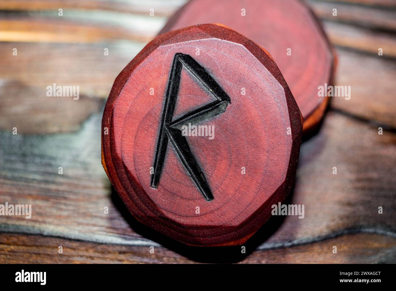 Rune Raido red color carved from wood on a wooden background - Elder ...