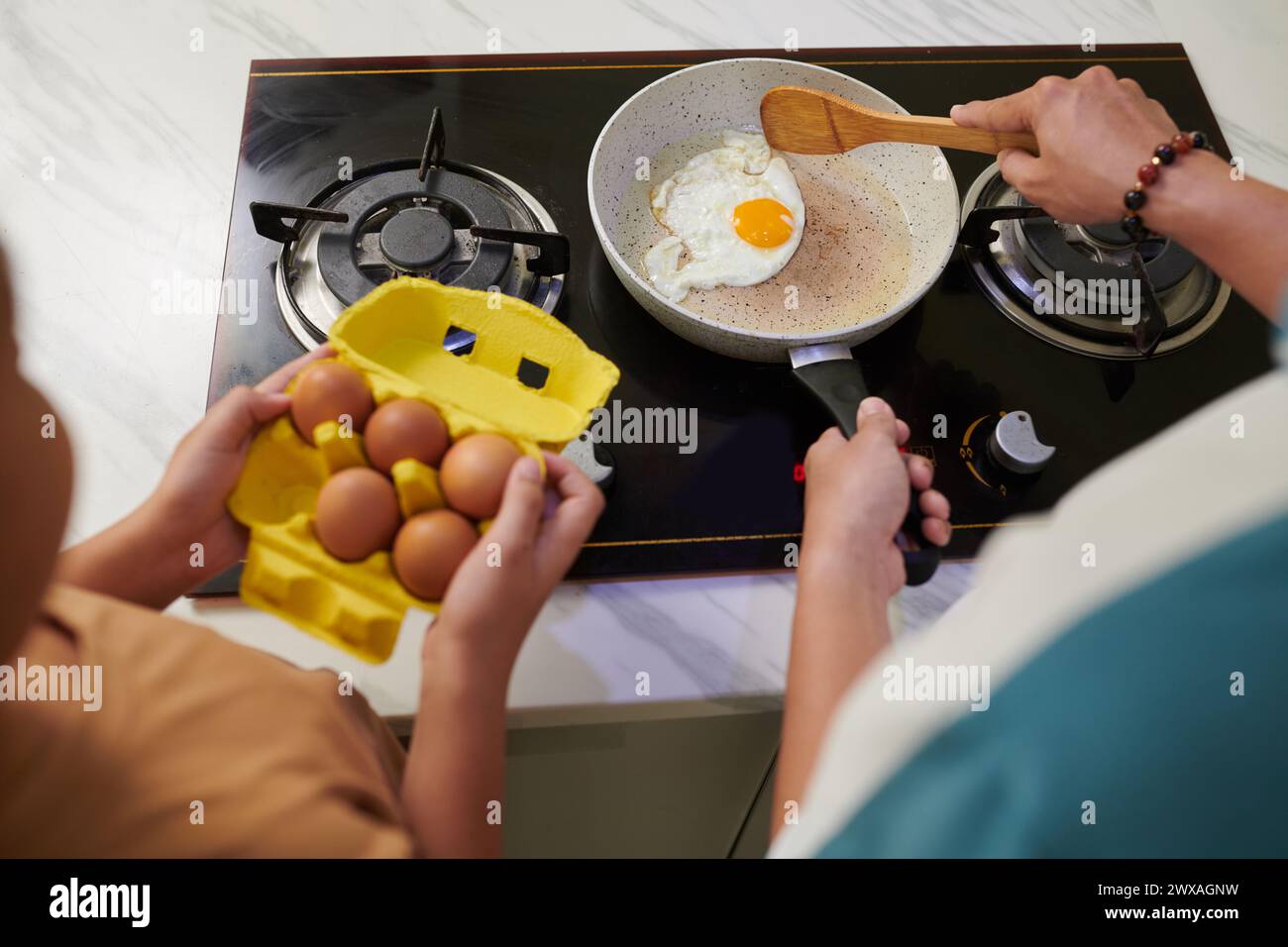 Father and son frying eggs for breakfast, view from above Stock Photo ...