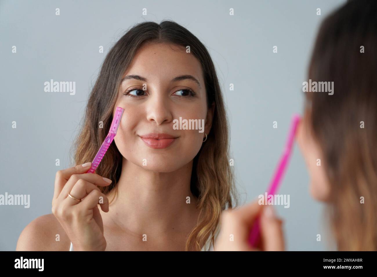 Facial hair removal. Dermaplaning. Close-up of beautiful teenager girl ...