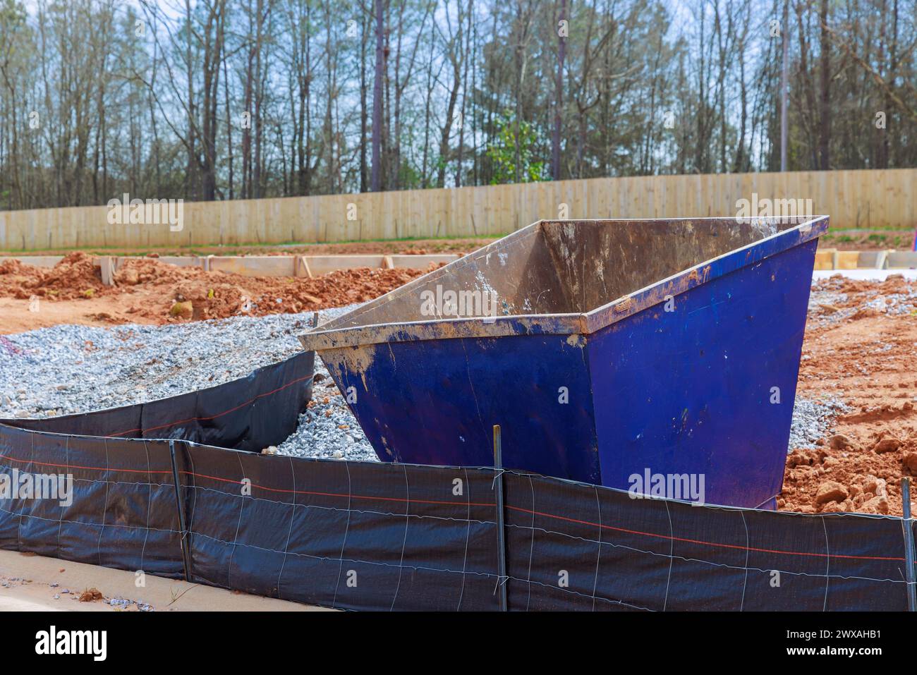 On construction site, metal container dumpster is used to store ...