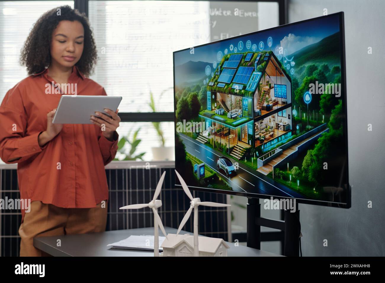 Screen with new architectural project and two models of windmill ...