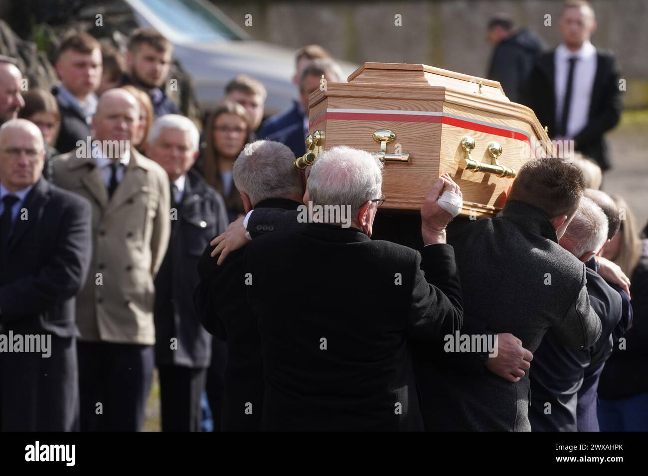 The coffin of Keith Morrison is taken from the back of a truck as it ...