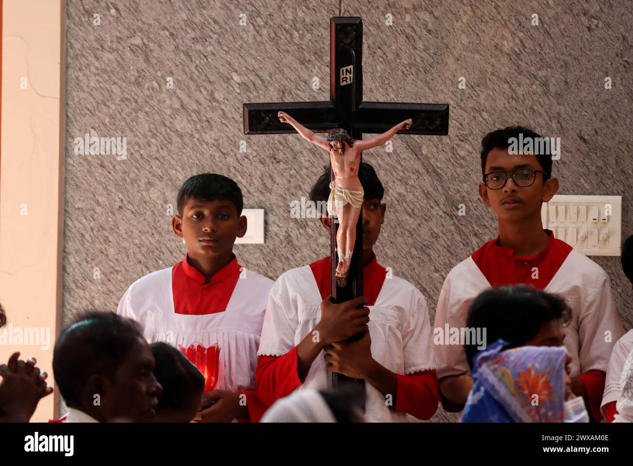 Chennai, India. 29th Mar, 2024. Christian devotees touch and kiss a ...