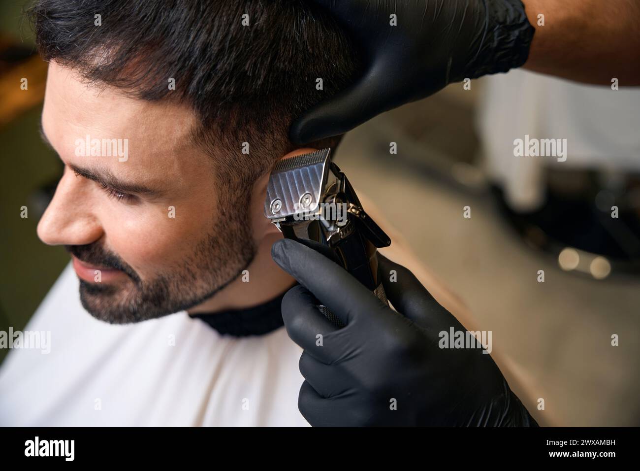 Barber using hair clipper for making stylish haircut for customer Stock ...