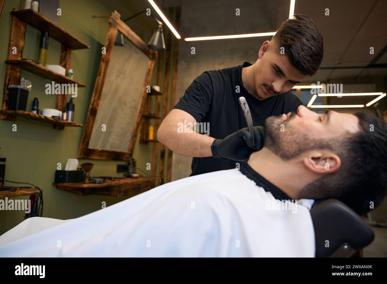 Barber trimming mans beard hi-res stock photography and images - Alamy