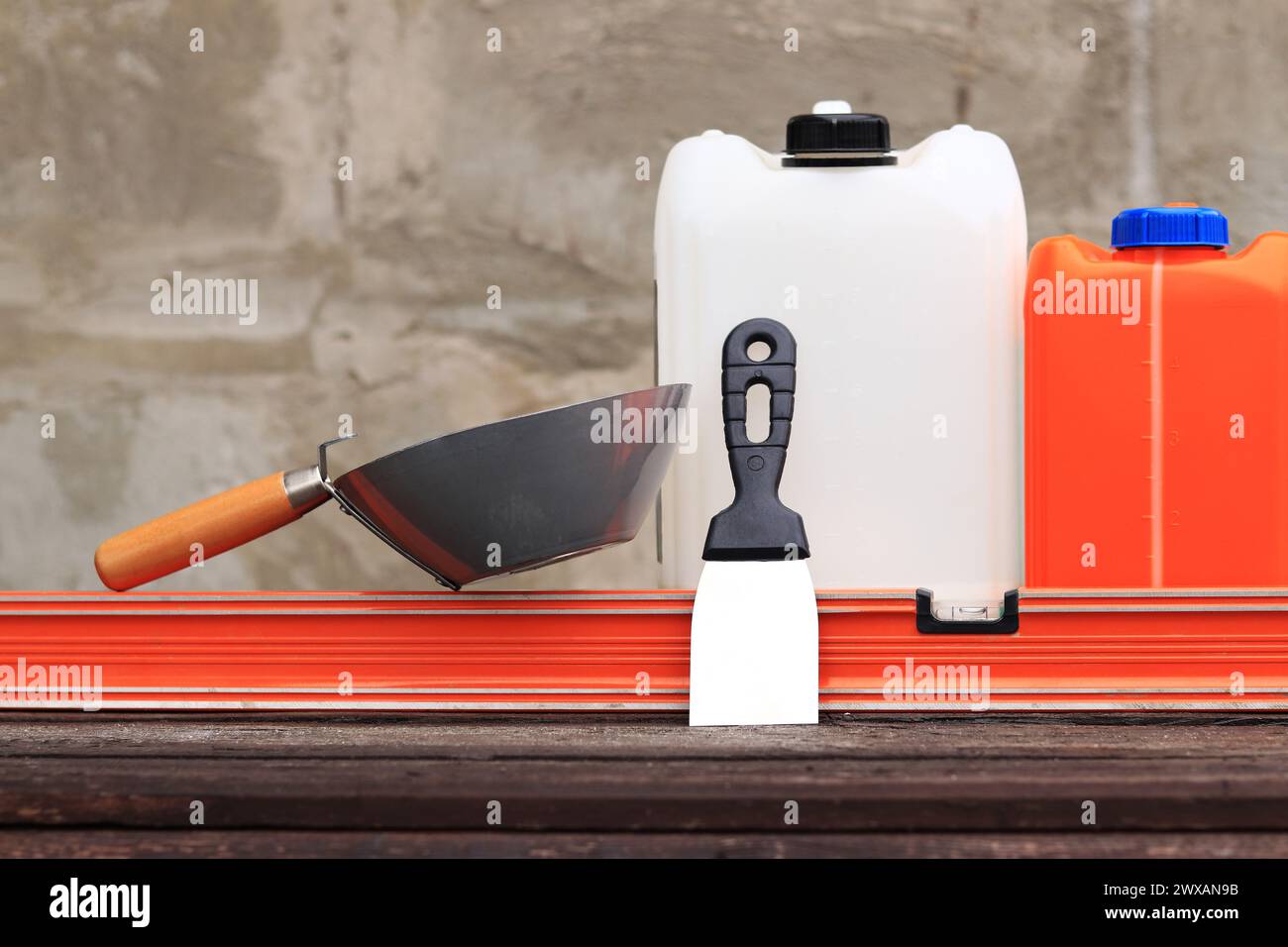 Construction or plastering ladle, a spatula, a construction level and a ...