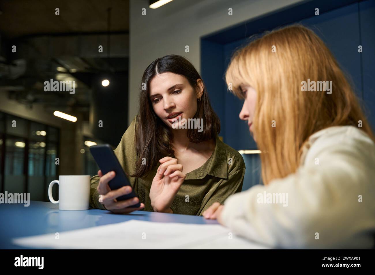 Fashion professionals in coworking environment sharing ideas of ...