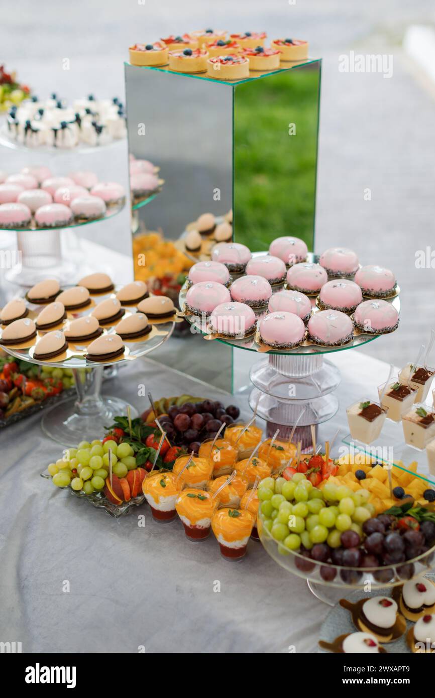 A variety of delectable desserts and pastries are artfully arranged on a table, showcasing a ...