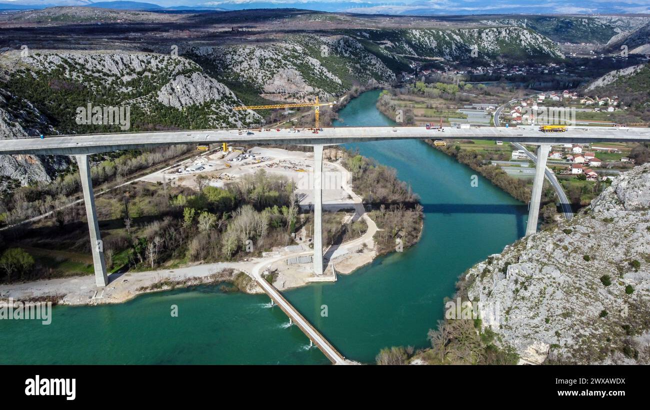 Construction of a high bridge over the river, aerial drone view ...