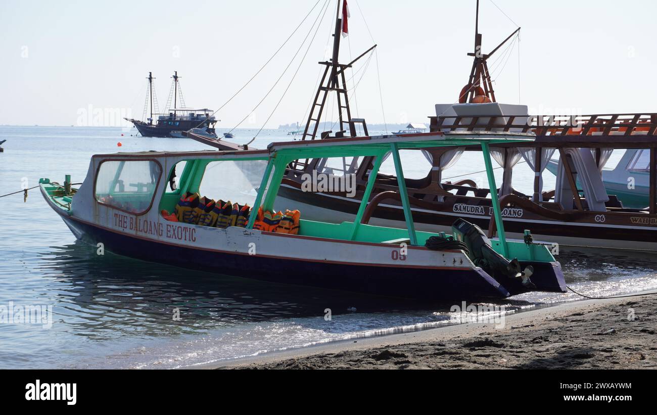 Some boats belonging to Lombok residents are leaning on the beach. This ...