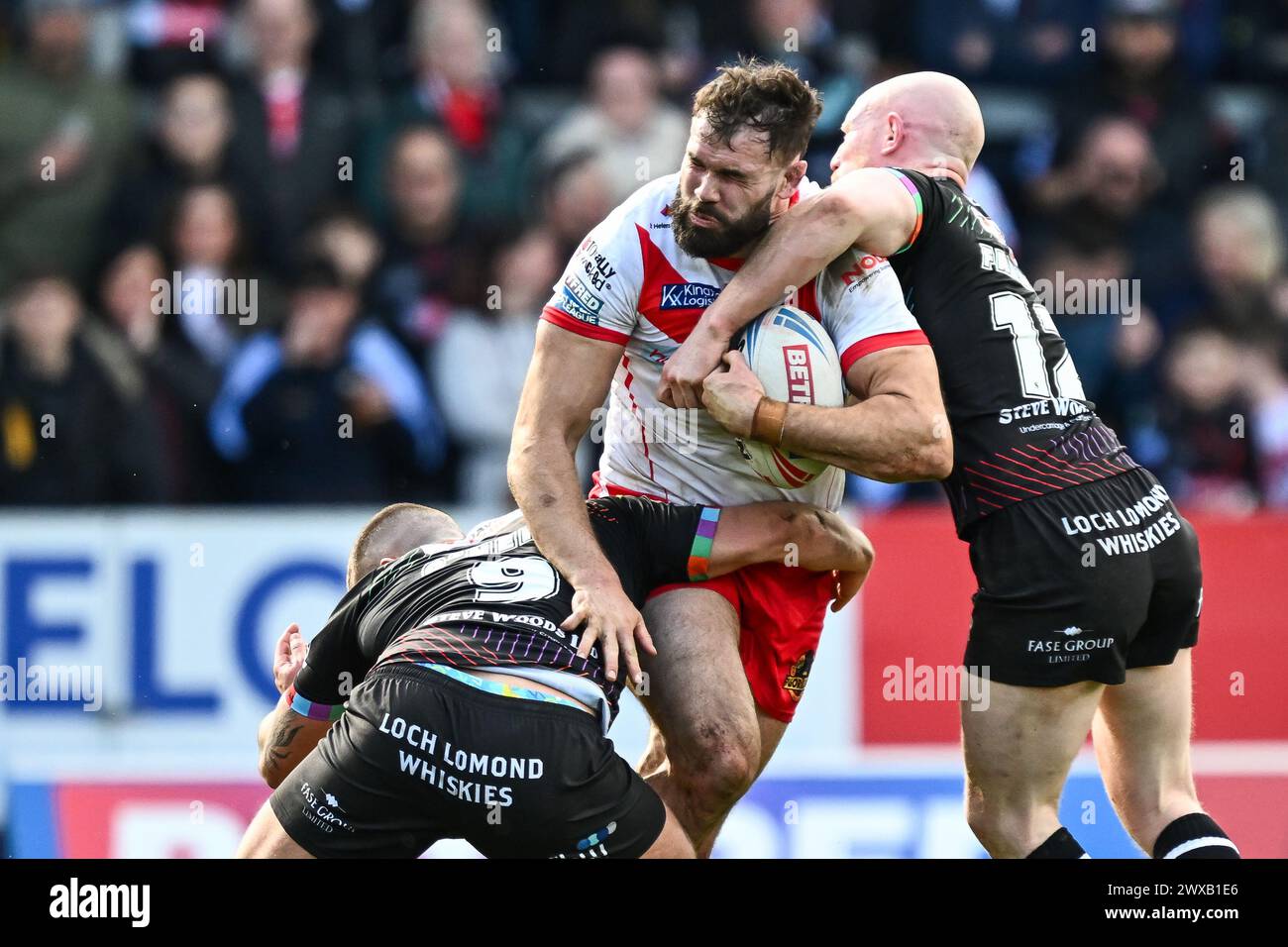 Alex Walmsley of St. Helens is tackled by Liam Farrell of Wigan ...