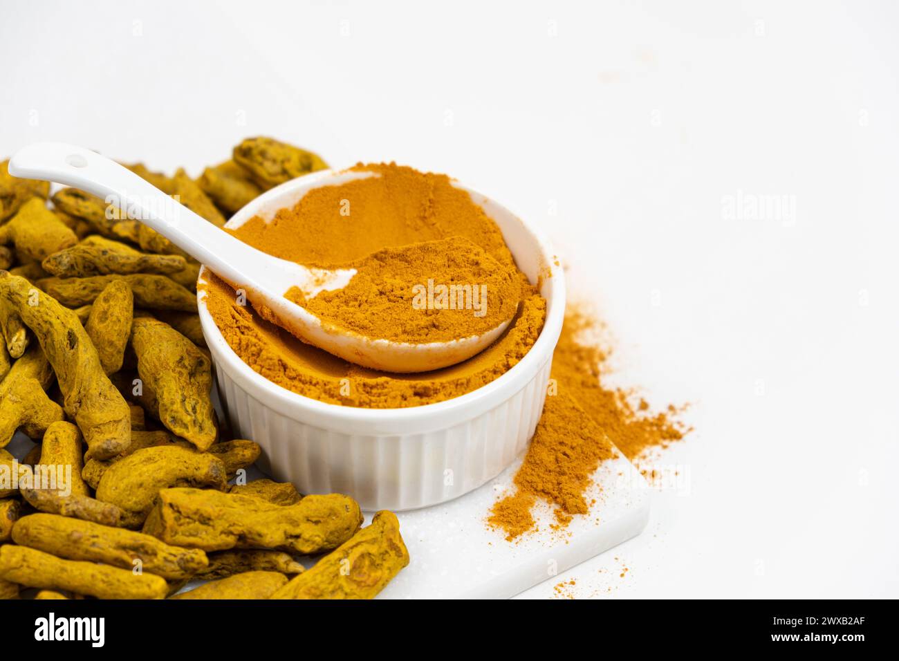 Turmeric powder, spices and dried root on white background Stock Photo ...