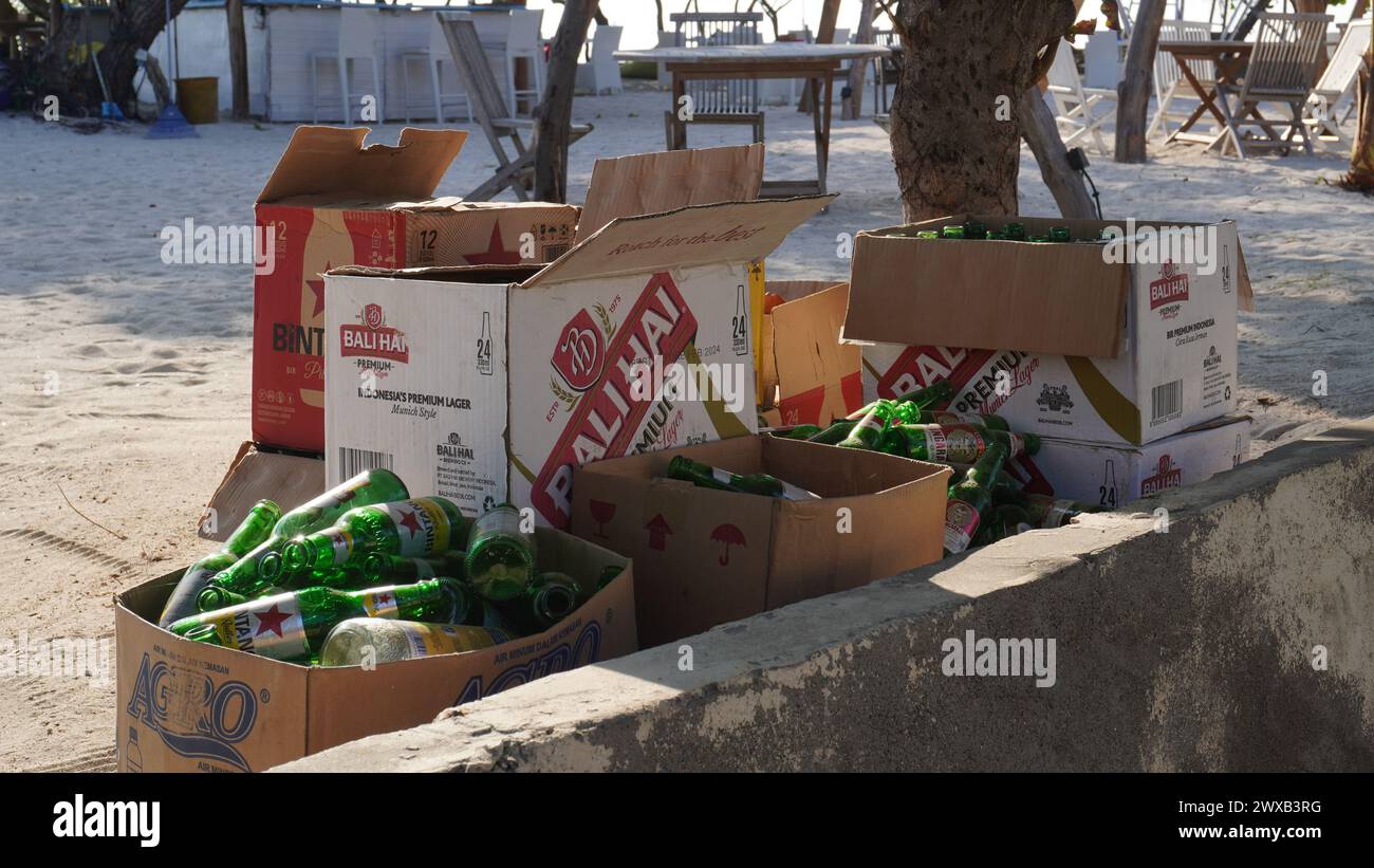 Used Bali Hai alcohol bottles stacked in boxes and placed on the beach ...
