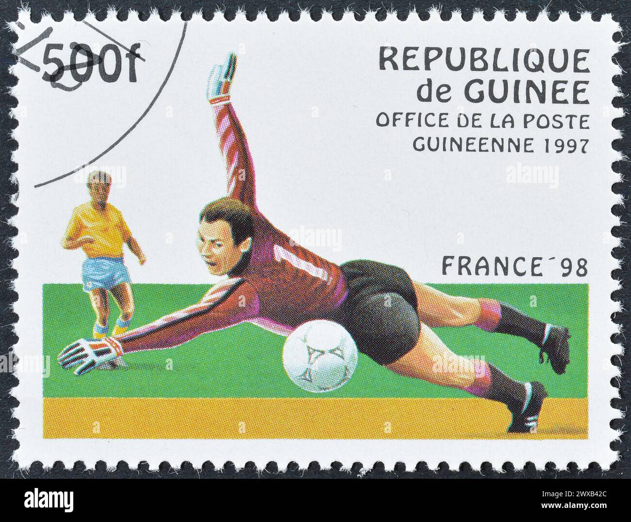 Cancelled postage stamp printed by Guinea, that shows Football players ...