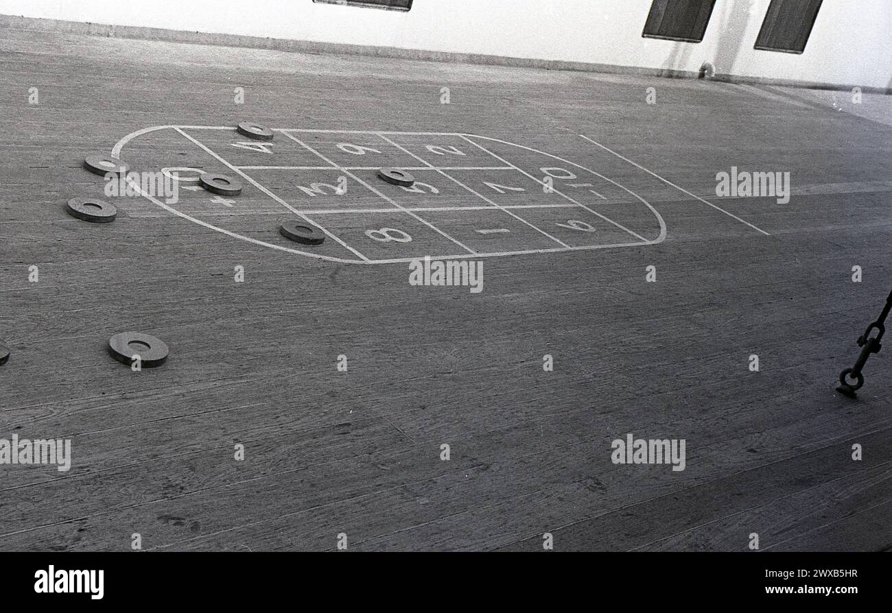 1950s, historical, on the deck of a passenger ship, rubber hoops and ...