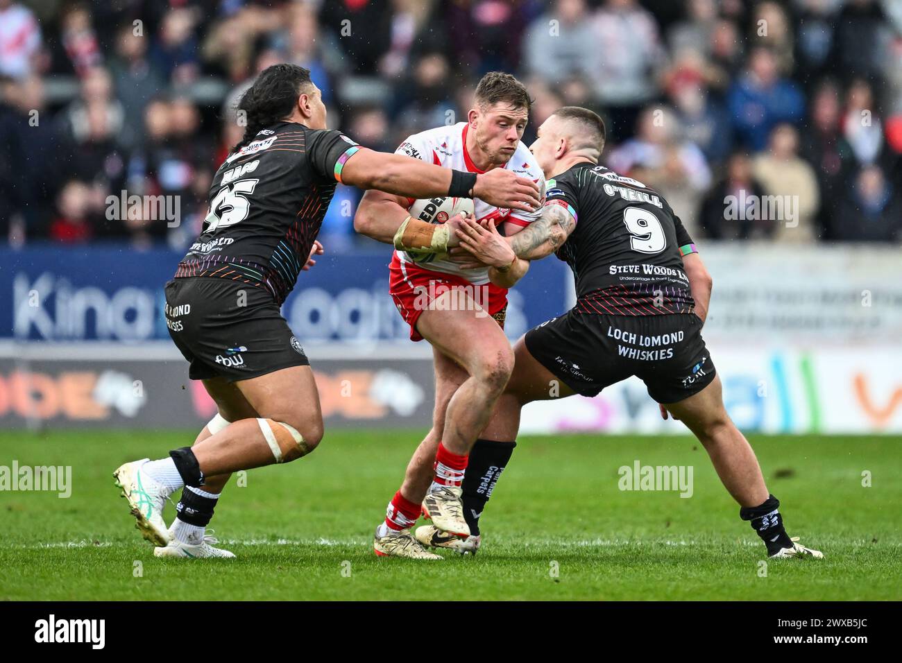 Morgan Knowles of St. Helens is tackled by Brad O’Neill of Wigan ...