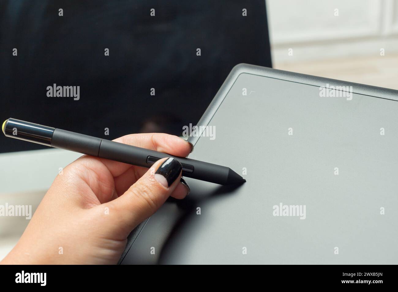 Hand of graphic designer working with stilus and tablet Stock Photo - Alamy