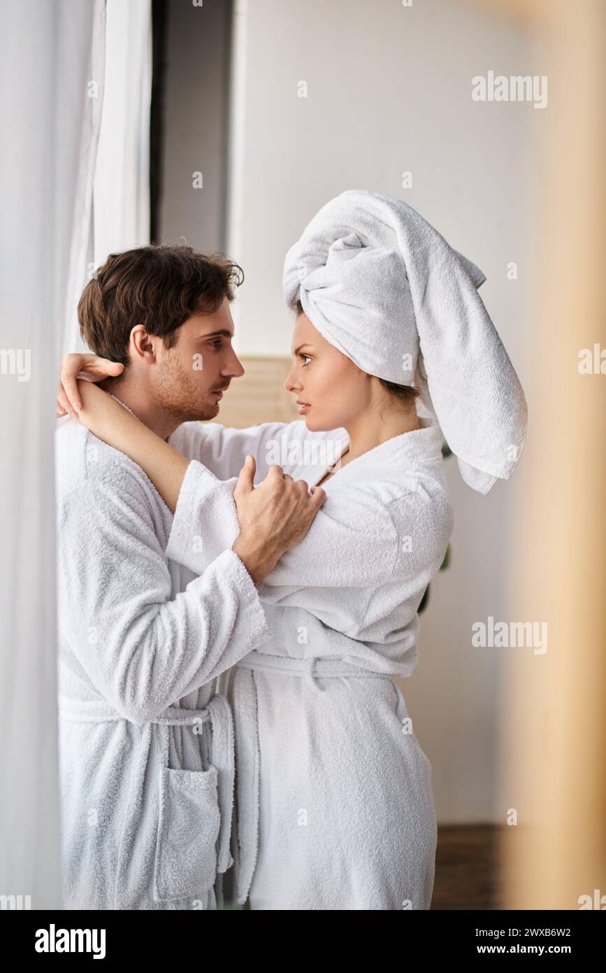 Attractive couple in love in bathroom hugging and cuddling, man ...