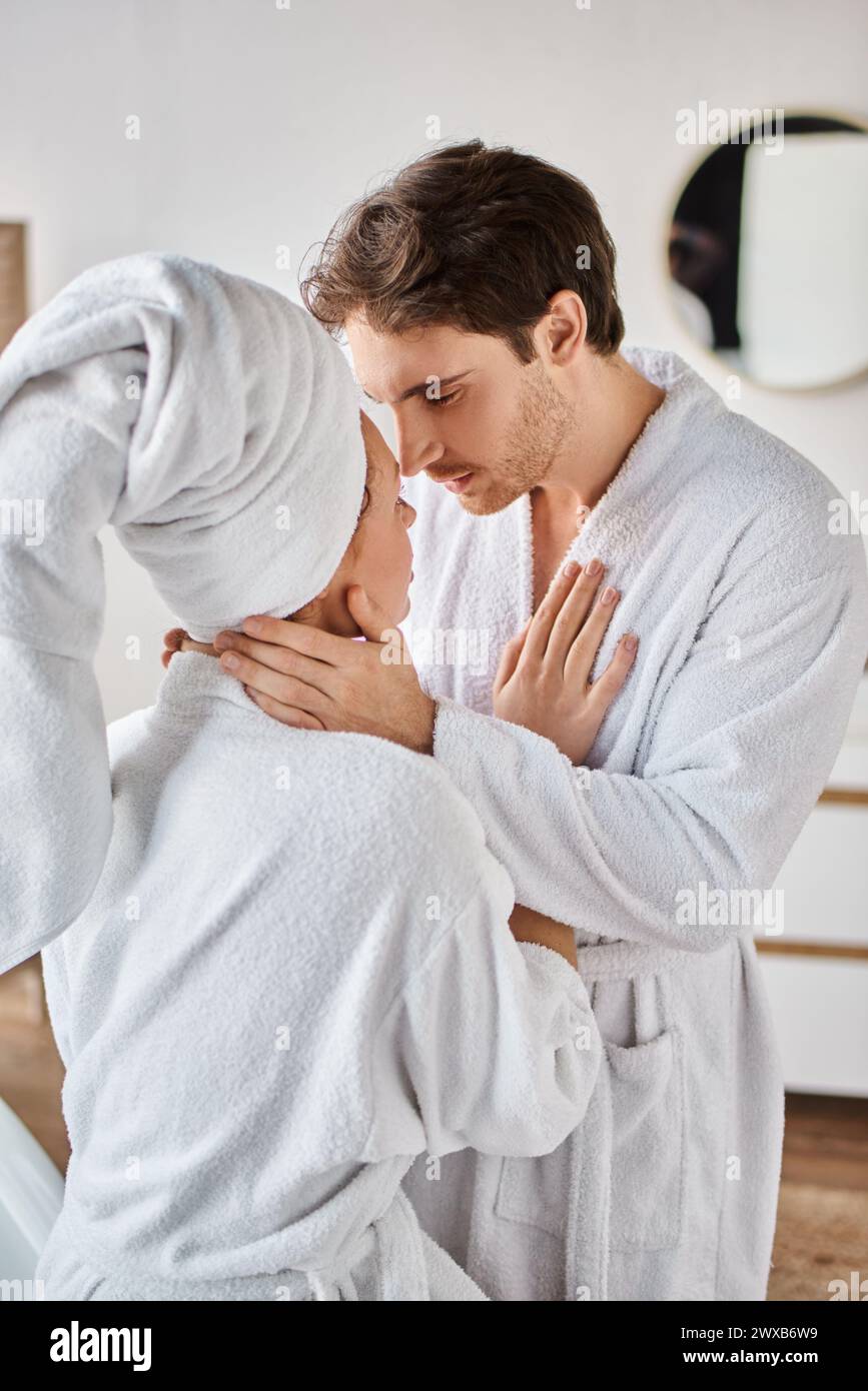 Attractive couple in love in bathroom hugging and cuddling, man ...
