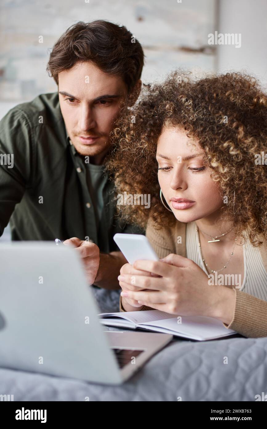 Couple working from home. Concerned man looking at laptop screen ...