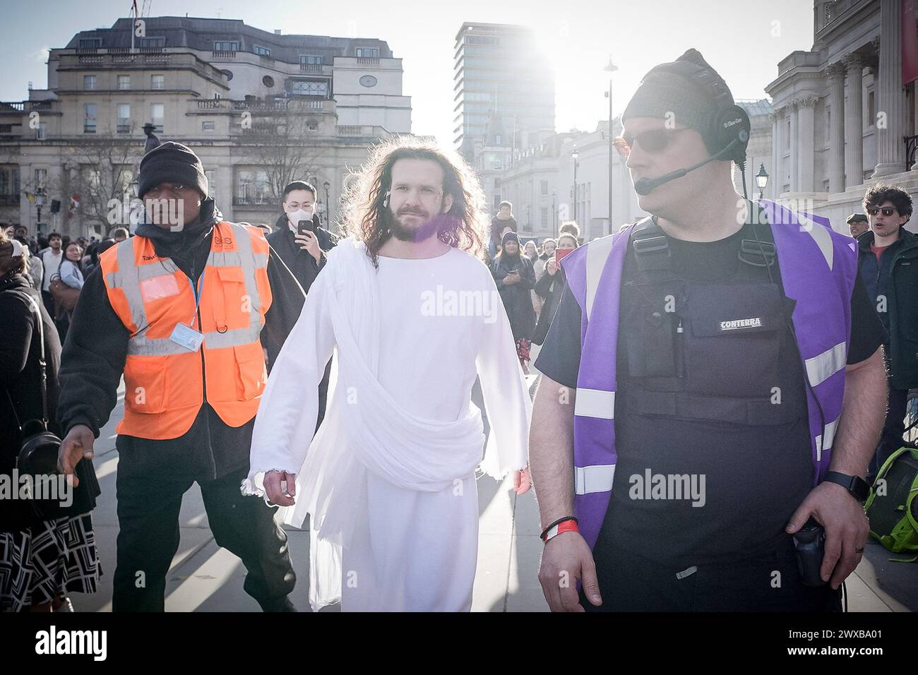 London, UK. 29th March, 2024. Peter Bergin as Jesus with his security ...