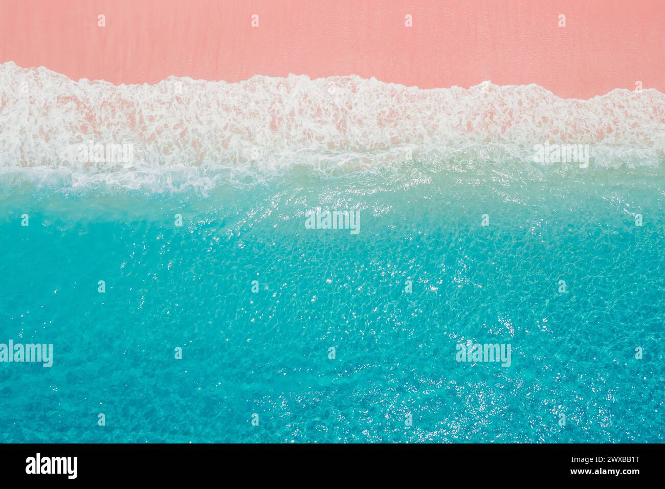 Pink sandy beach with blue ocean in Komodo national park Stock Photo ...