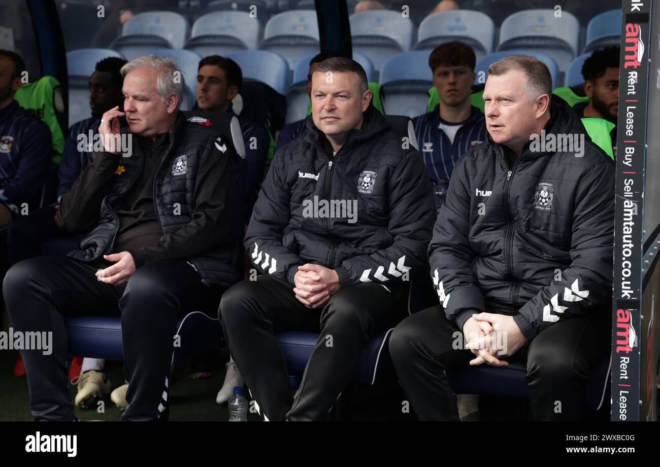Coventry City manager Mark Robins (right) on the bench with the ...