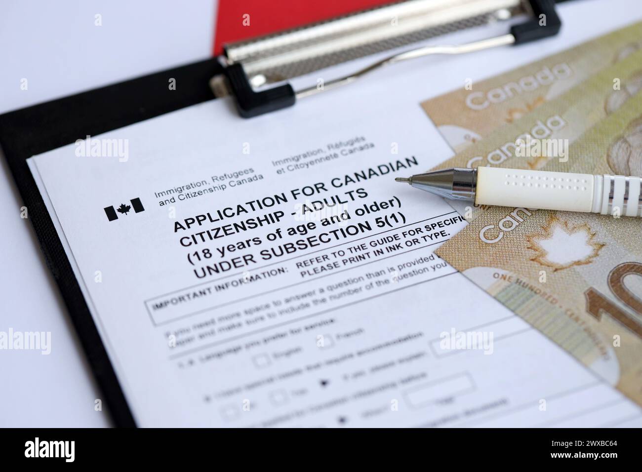 Application for Canadian citizenship for adults on table with pen and ...