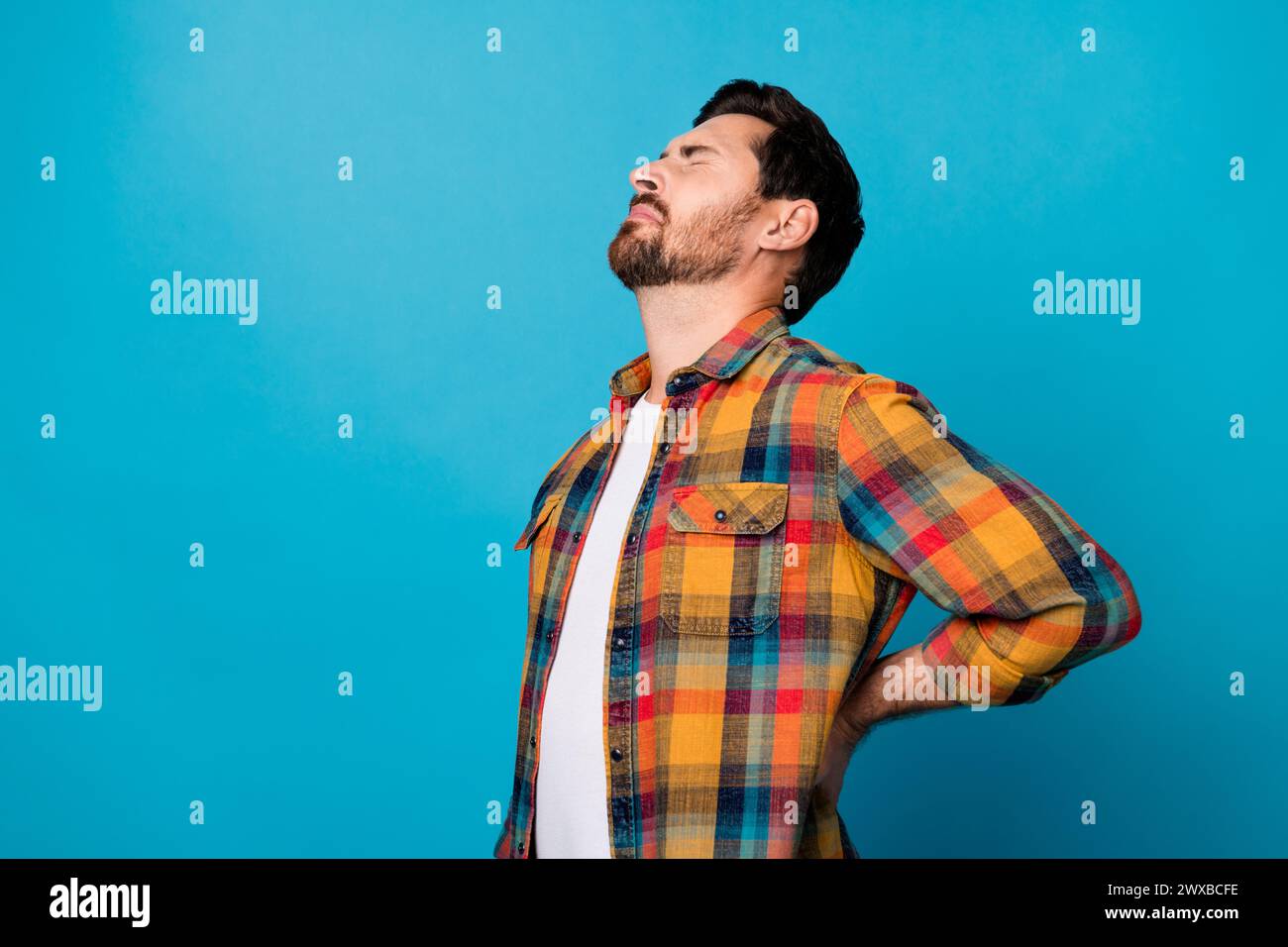 Photo portrait of nice young guy touch lower back suffer pain dressed ...