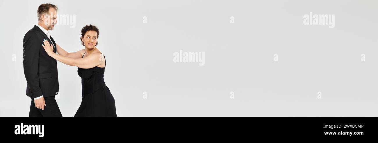 Side view shot of mature attractive smiling couple in a tango dance ...