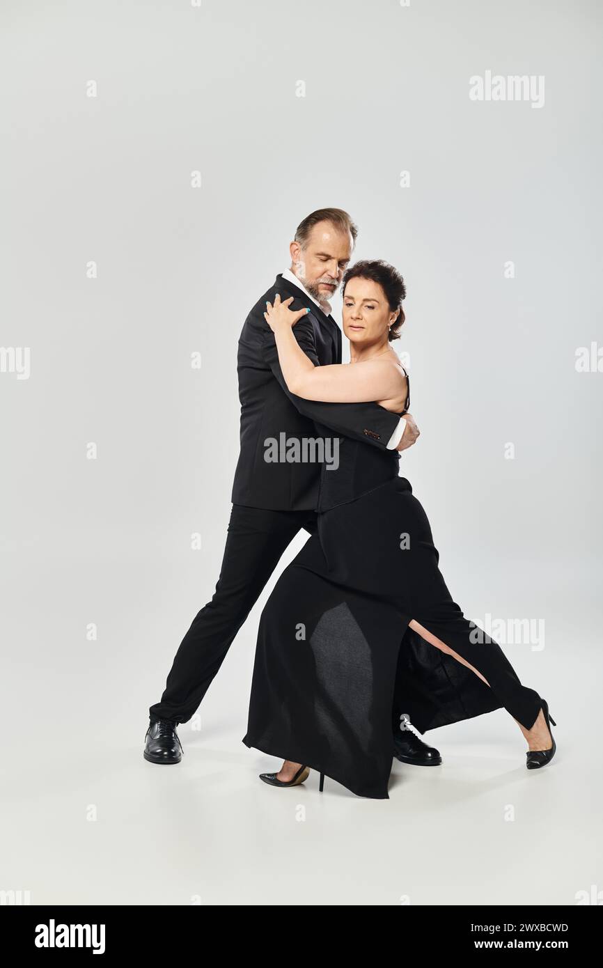 Side view shot of mature attractive couple in a tango dance pose ...