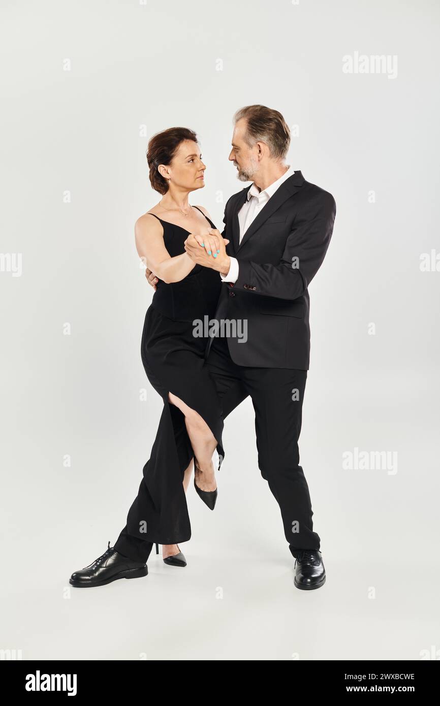 Ballroom dance middle aged couple in a dance pose and smiling isolated ...